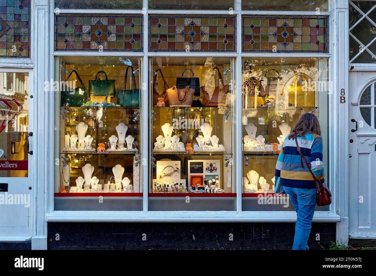 Female window shopper in Sidmouth Devon Stock Photo - Alamy