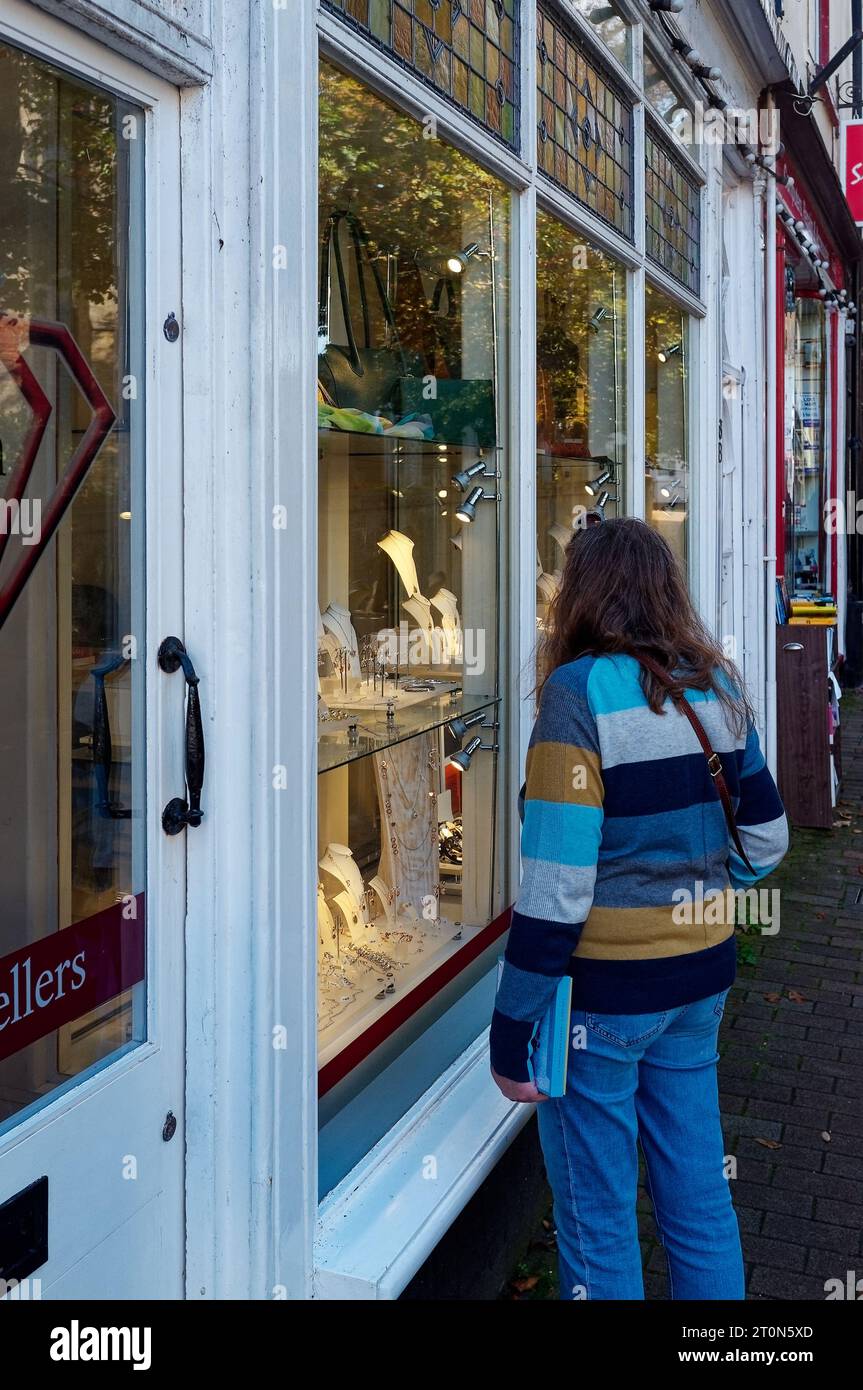 Female window shopper in Sidmouth Devon Stock Photo - Alamy