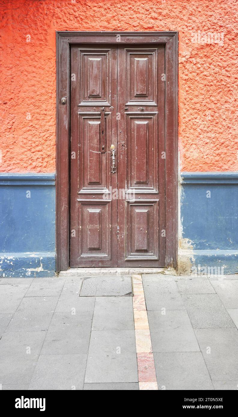 Street view of an old colonial building facade with wooden door ...
