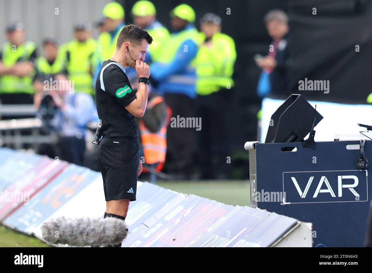 Referee Nick Walsh consults the on-pitchside VAR after a possible ...