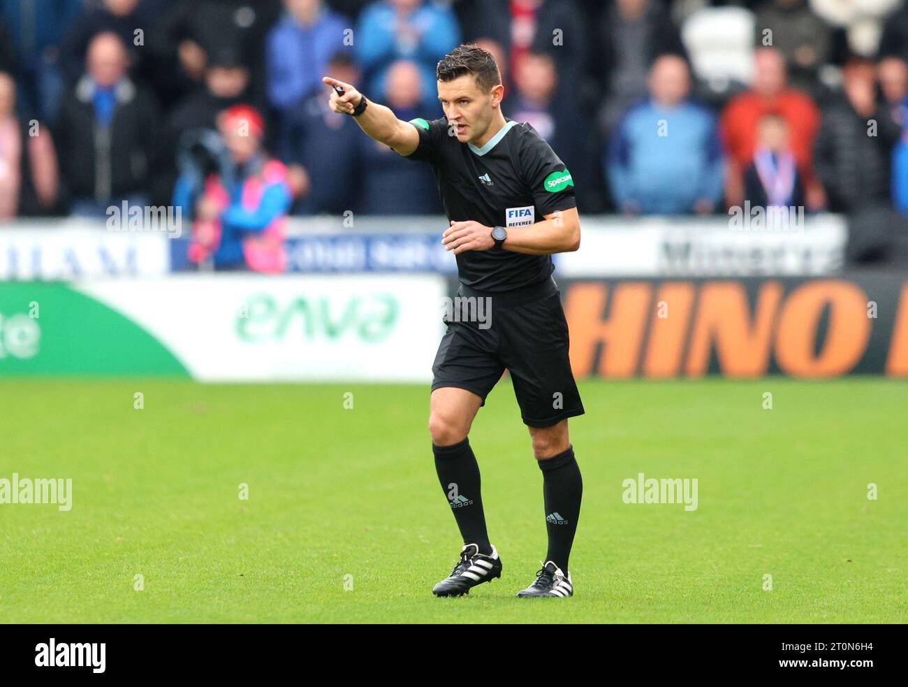 Referee Nick Walsh signals for a penalty following a VAR check on a ...