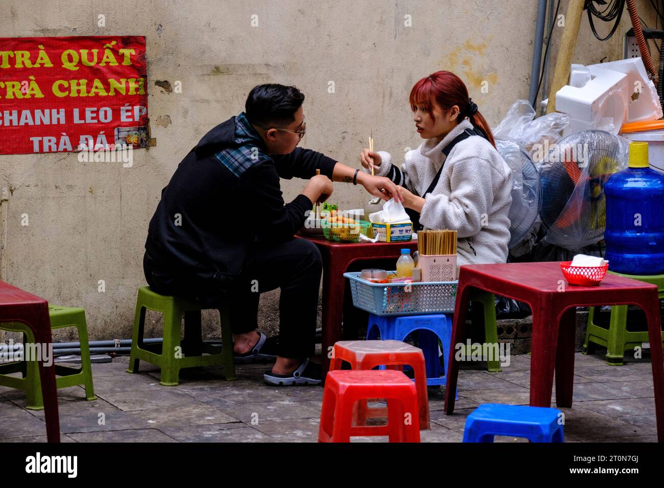 Hanoi, Vietnam. Couple Having Lunch at a Sidewalk Fast Food Stand Stock ...