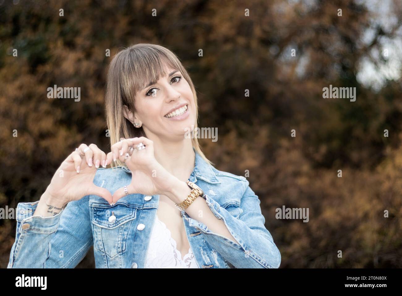Heartfelt Gesture: woman Making Heart Shape in Nature Stock Photo - Alamy