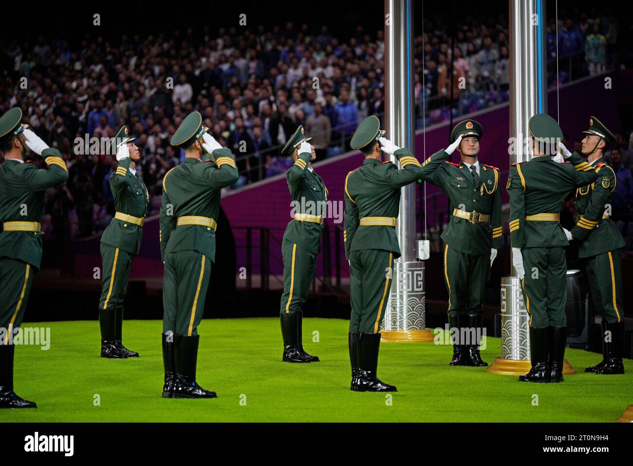 Military soldiers salute as a Chinese flag is raised during the closing ...