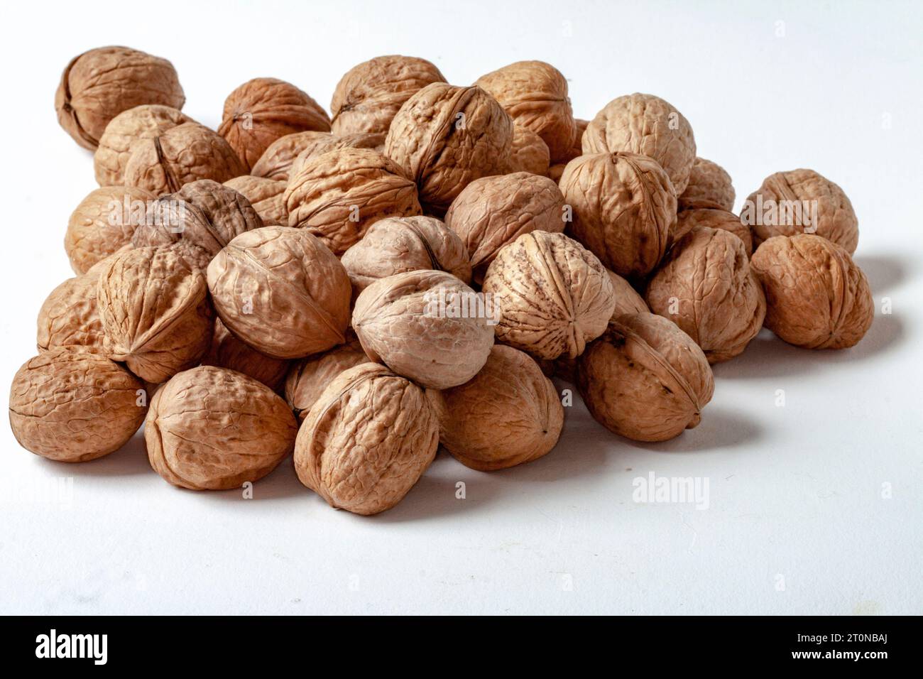 Loose nuts on white background Stock Photo - Alamy