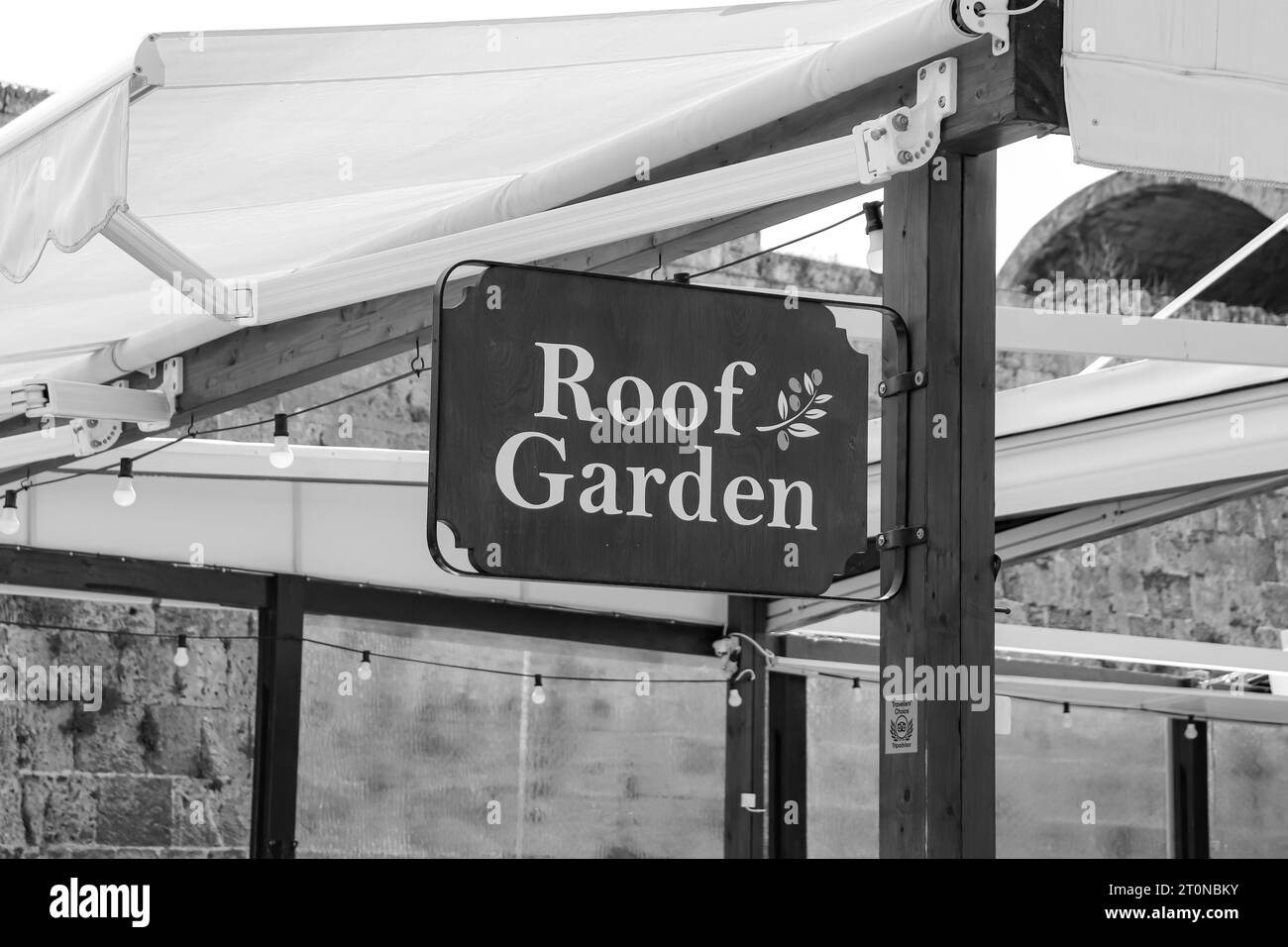 Roof Garden wooden sign hanging on a wooden pole in black and white ...