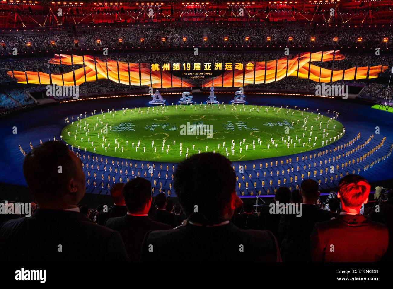 Security personnel watch the closing ceremony of the 19th Asian Games ...