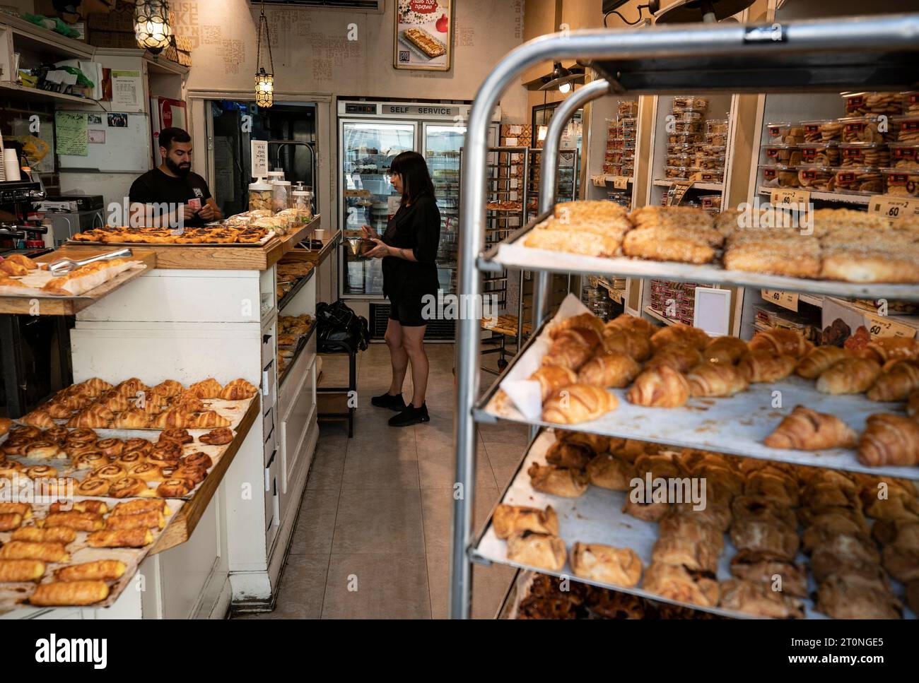 Jerusalem. 8th Oct, 2023. A woman buys bread at a bakery in Jerusalem ...
