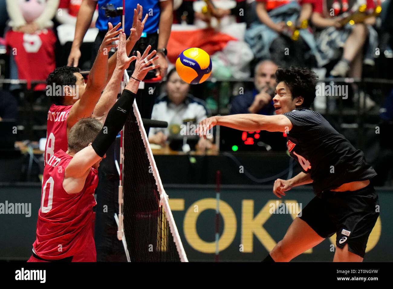 Japanese player Kento Miyaura, right, spikes the ball against the U.S ...
