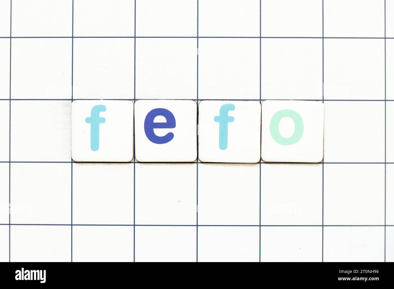 Colorful tile letter in word FEFO (Abbreviation of first expired first ...