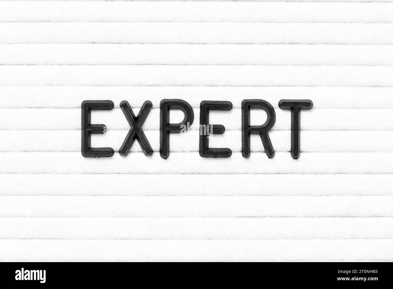 Black color letter in word expert on white felt board background Stock ...
