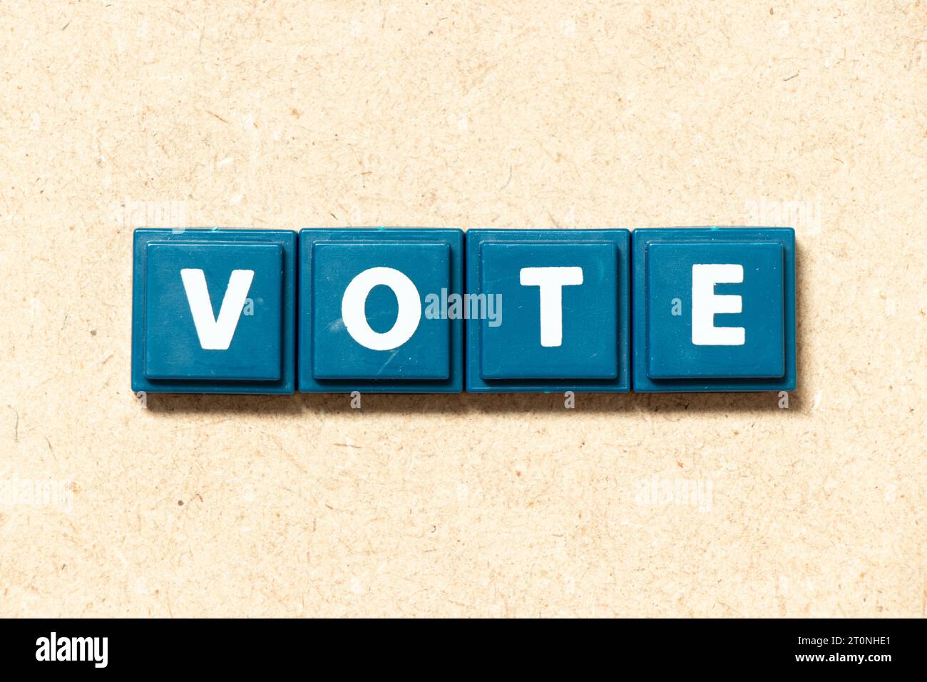 Tile alphabet letter in word vote on wood background Stock Photo - Alamy