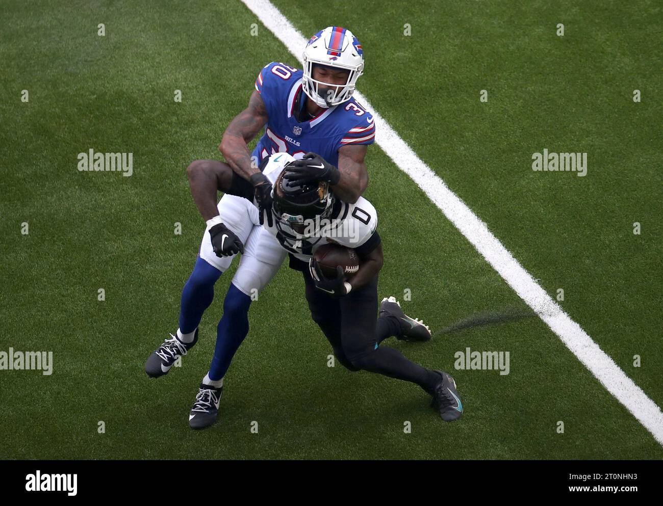 Jacksonville Jaguars Calvin Ridley (bottom) is tackled by Buffalo Bills ...