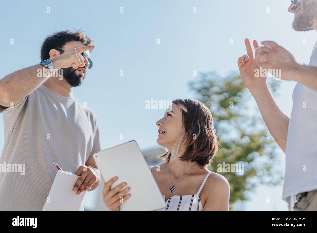 Collaborative team of architects and construction engineers discussing ...