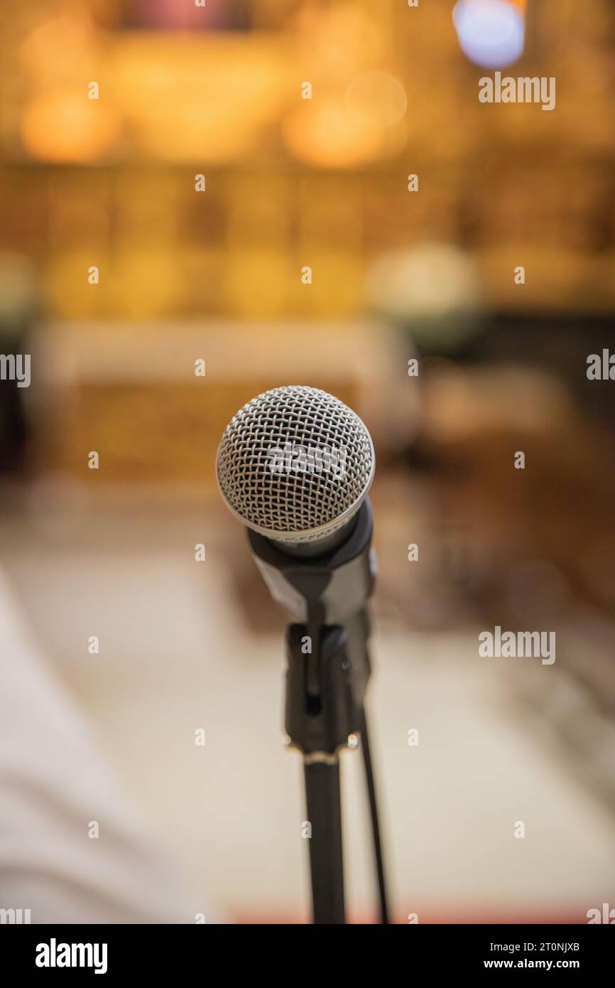 Microphone in the foreground ready to be used inside a church or ...