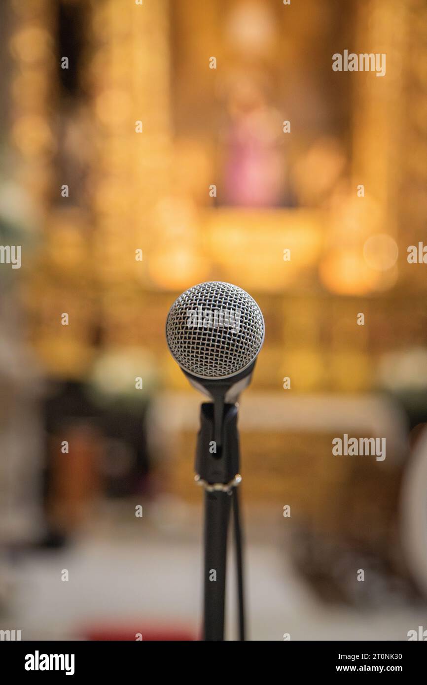 Microphone in the foreground ready to be used inside a church or ...
