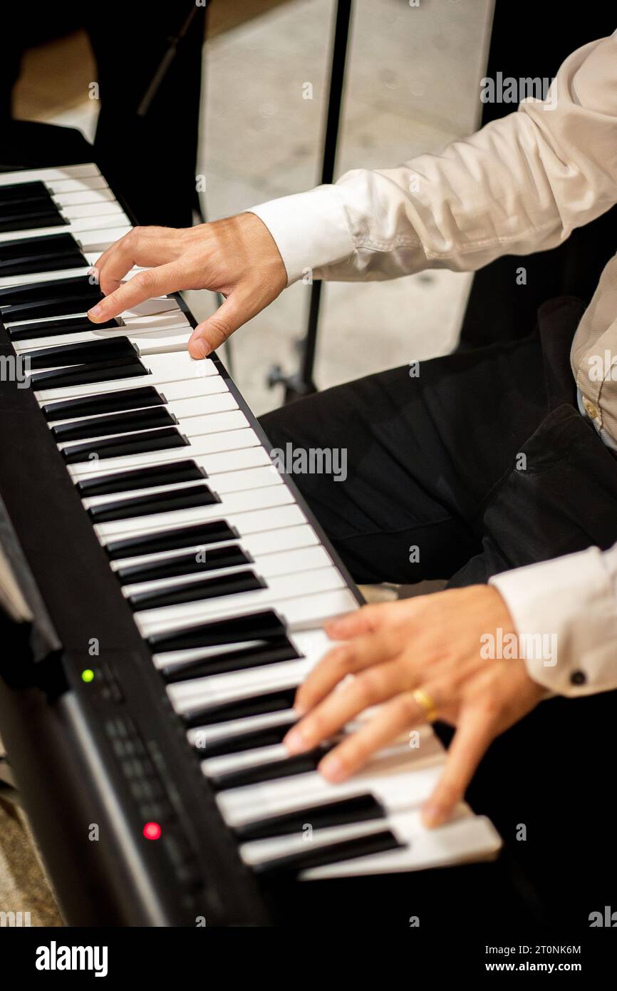 Detail of hands of a Caucasian man in classical clothing playing music ...