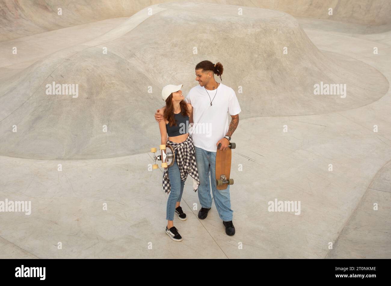 Young european couple embracing, posing with skateboards on ramp Stock ...