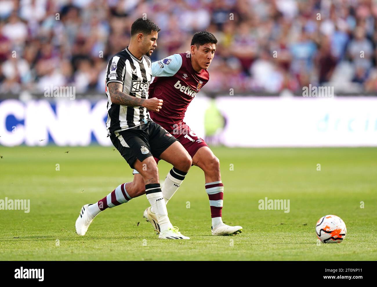 Newcastle United's Bruno Guimaraes (left) and West Ham United's Edson ...