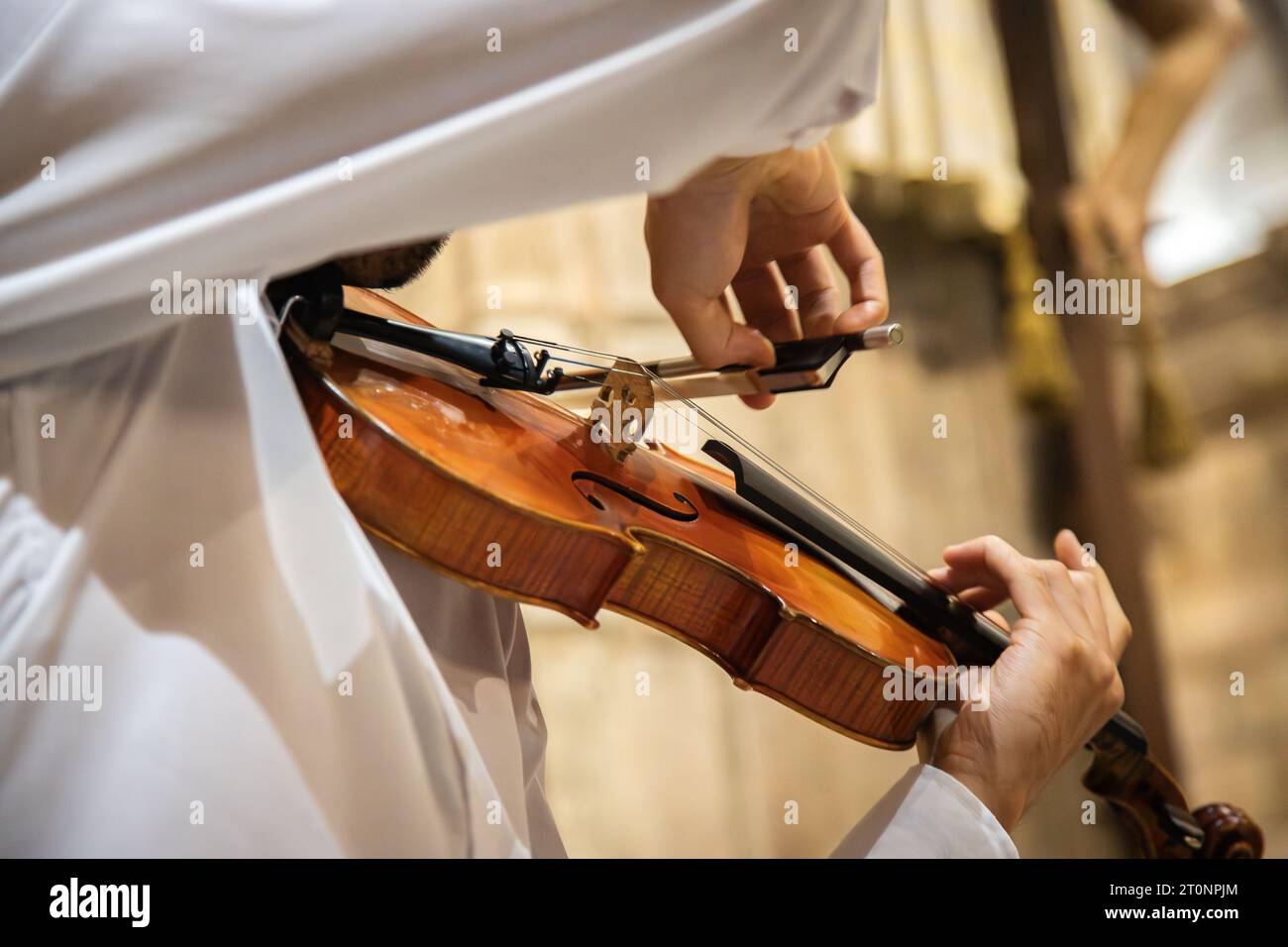 Caucasian violinist man wearing classical clothes and performing in a ...