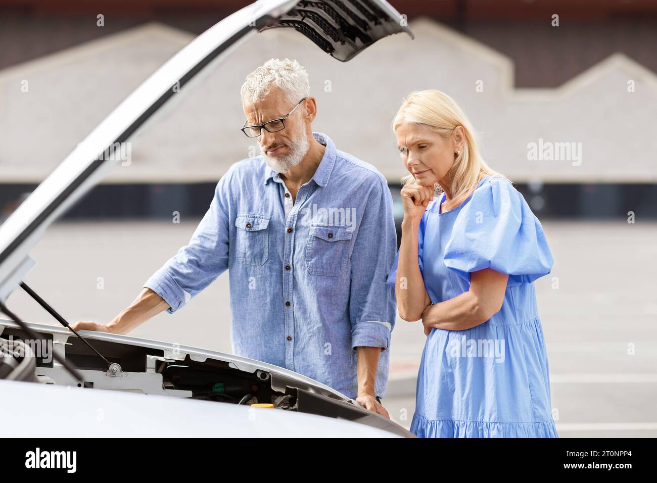 Upset senior couple in road trip experience problems, breakdown engine ...
