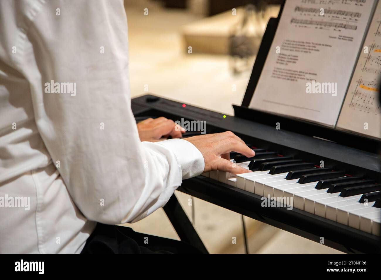 Detail of hands of a Caucasian man in classical clothing playing music ...