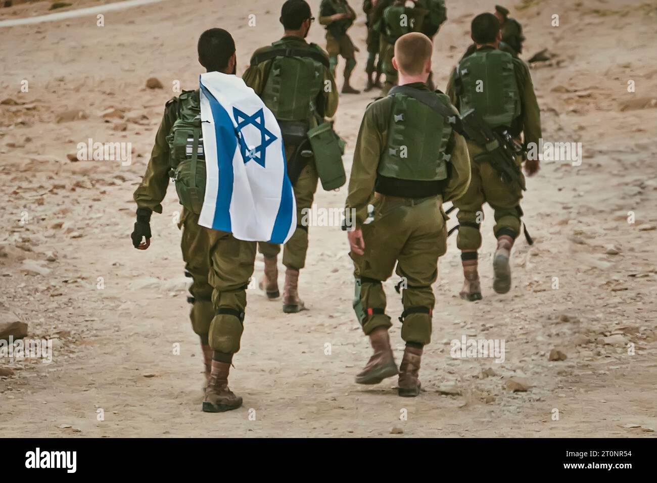 Back shot of several soldiers of israel army walking with an israel ...