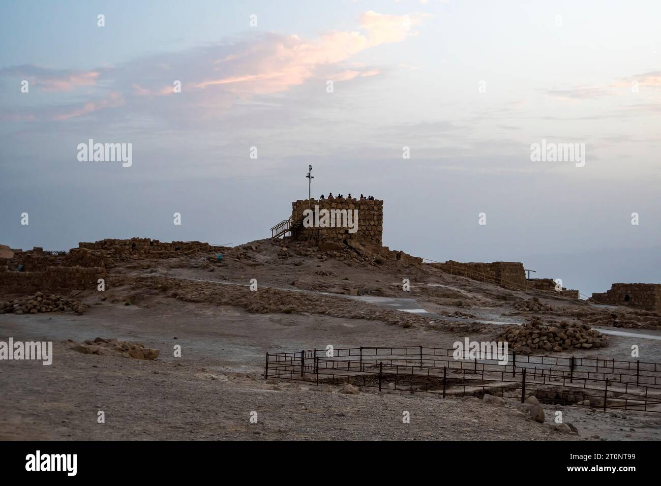 The tallest tower of Masada against the cloudy sky at dawn in the sun ...