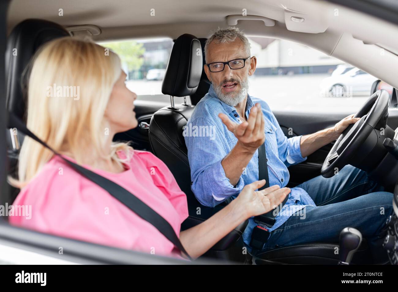 Emotional retired couple arguing, shouting at each other in car Stock ...