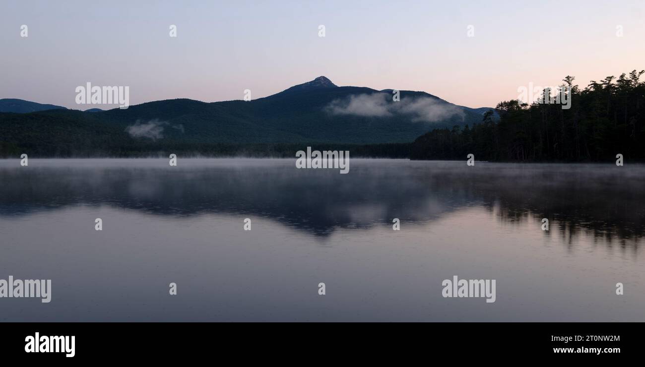 Mount Chocorua overlooks Chocorua lake as dawn breaks on a summer ...