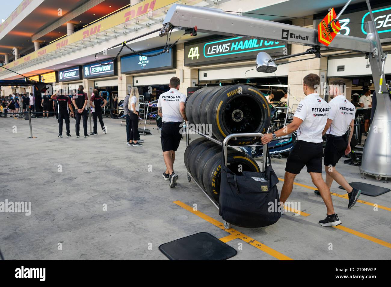 Mercedes mechanics roll in a stack of tires ahead of the Qatar Formula ...