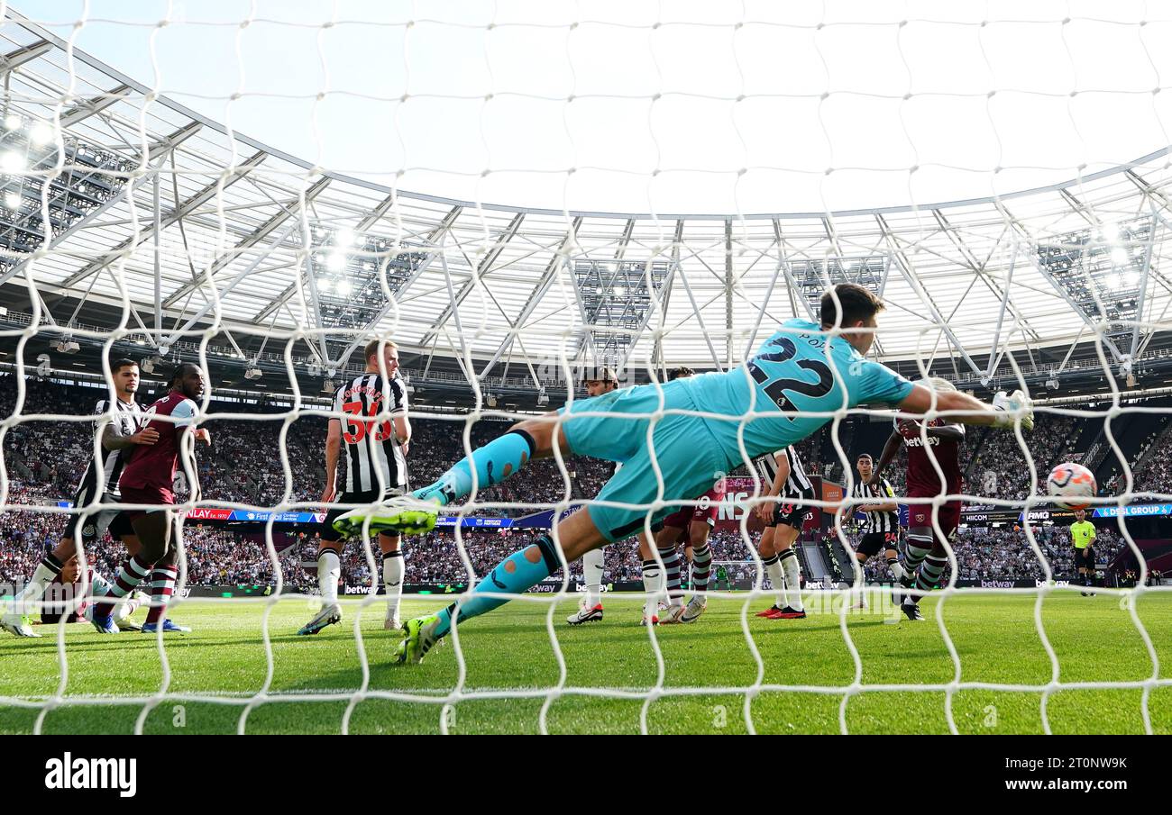Newcastle United goalkeeper Nick Pope attempts to dive towards the ball ...