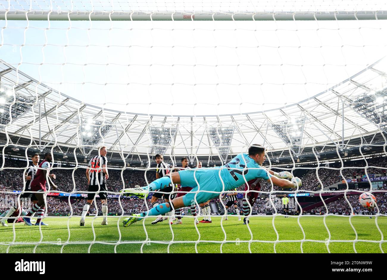 Newcastle United goalkeeper Nick Pope attempts to dive towards the ball ...