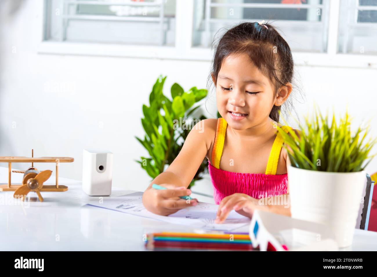 Child little girl drawing cartoon on paper before paint the color Stock ...