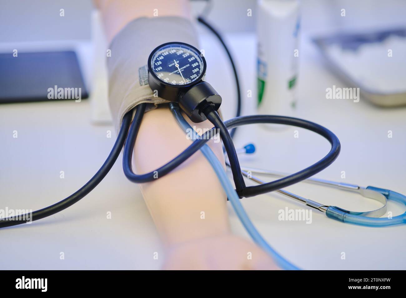 Doctor measuring blood pressure of a training dummy in hospital ...