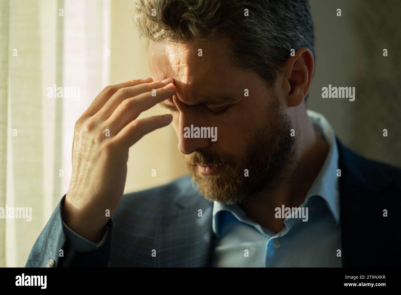 Headache, tiredness and stress. Close up portrait of man in suit got ...