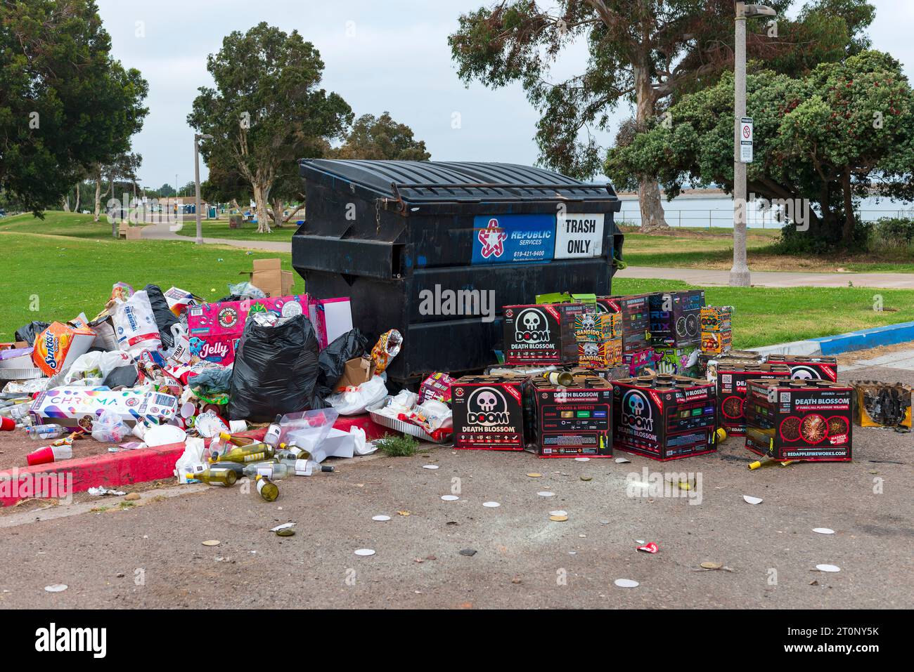 An accumulation of trash, broken wine bottles, and cases of illegal ...
