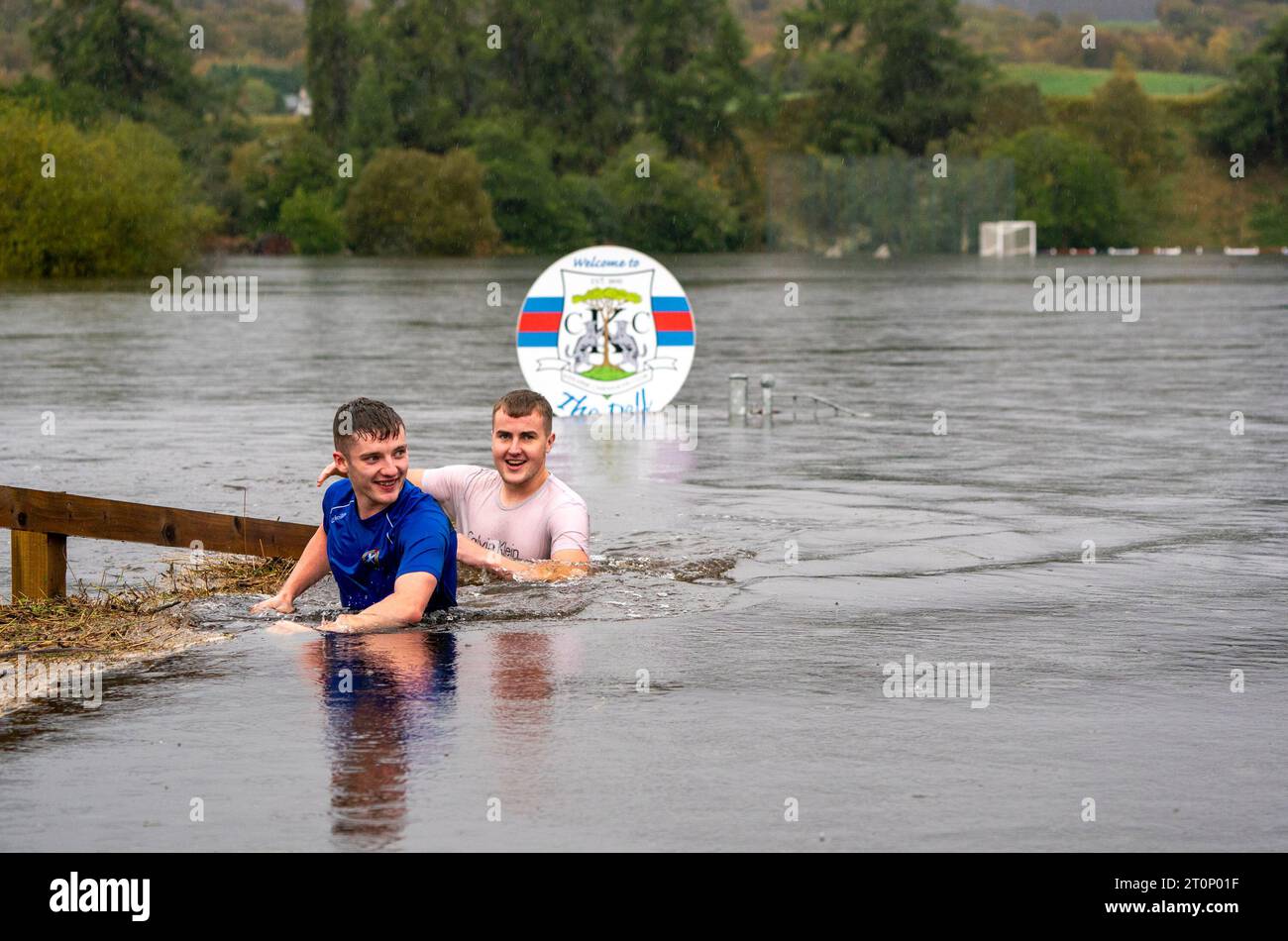 Two men swim in the flood waters near the Kingussie Camanachd Club at ...