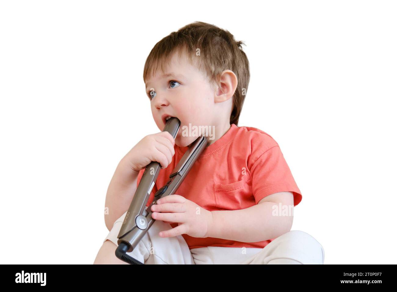 Child is putting himself in harm's way by playing with hair tongs ...