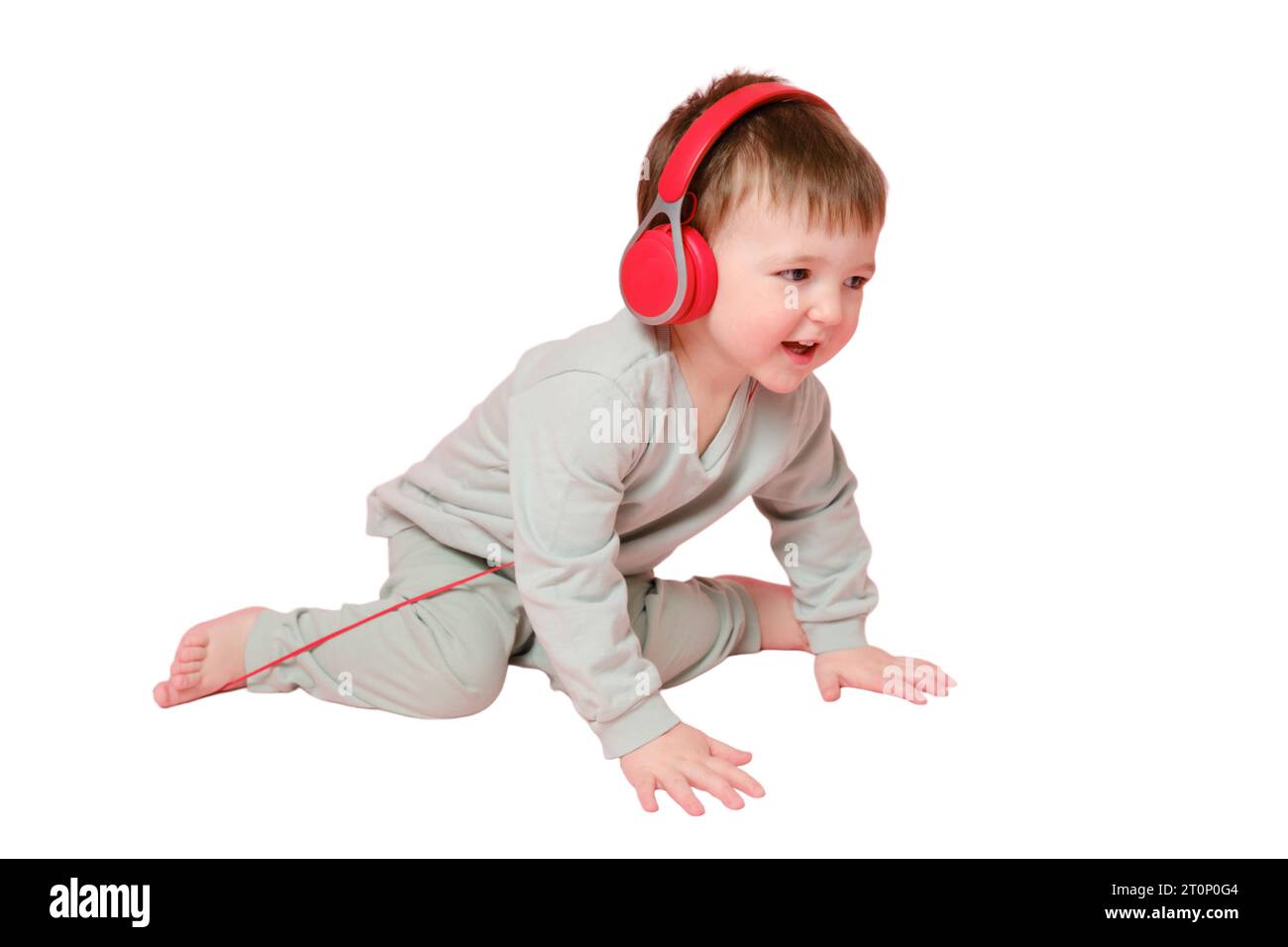 Happy toddler baby listens to music with headphones on studio, isolated ...
