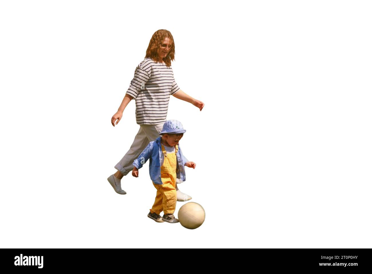 The child and woman mother is having fun kicking the soccer ball around ...