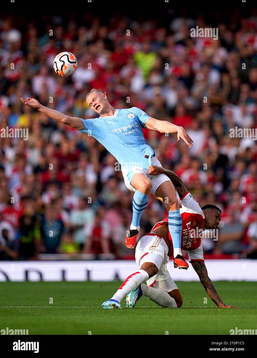 Manchester City's Erling Haaland (top) and Arsenal's Gabriel battle for ...