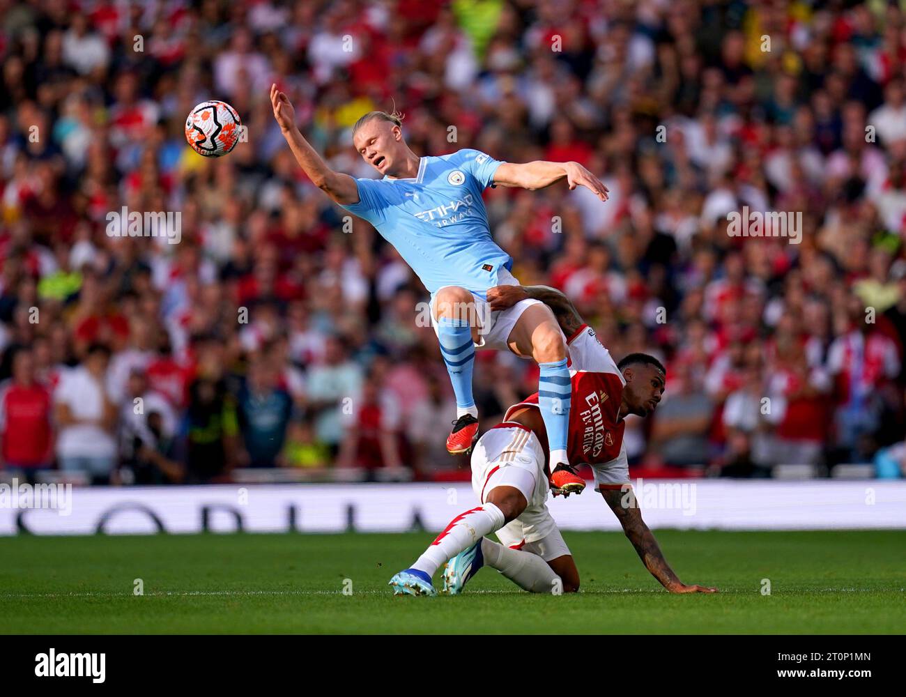 Manchester City's Erling Haaland (top) and Arsenal's Gabriel battle for ...
