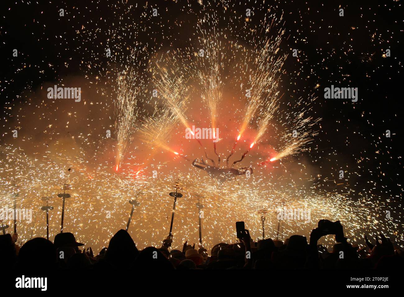 People dancing under showers of sparks from fireworks at the annual ...