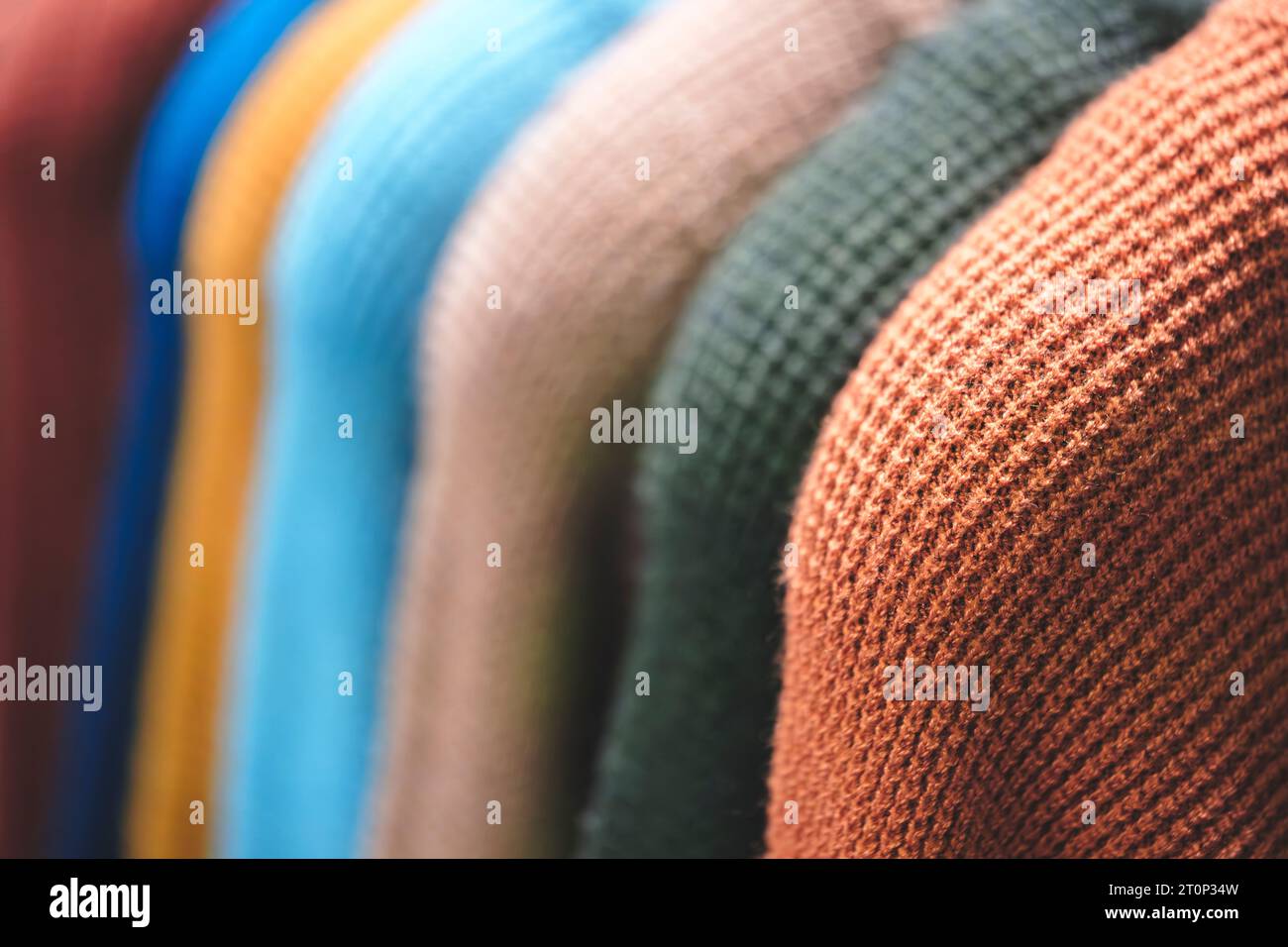 Fashion hoodie clothes on clothing rack Closeup of rainbow color choice ...