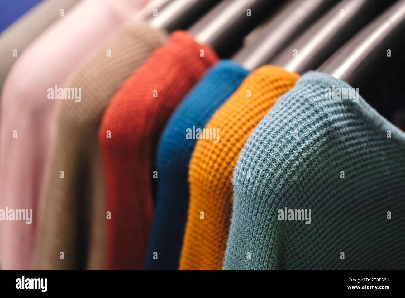 Fashion hoodie clothes on clothing rack Closeup of rainbow color choice ...