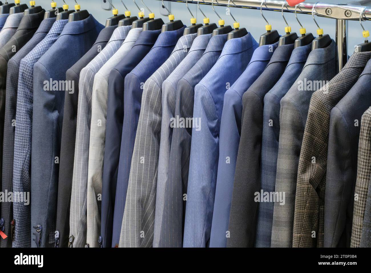 Racks with different men's suits in a men's clothing boutique Stock ...