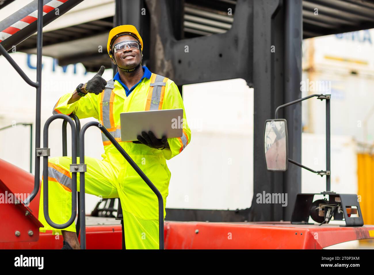 African male dock worker control loading containers cargo at warehouse ...