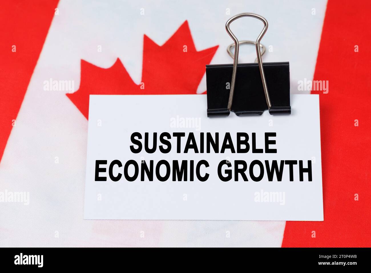 Economy and finance concept. On the flag of Canada lies a business card ...