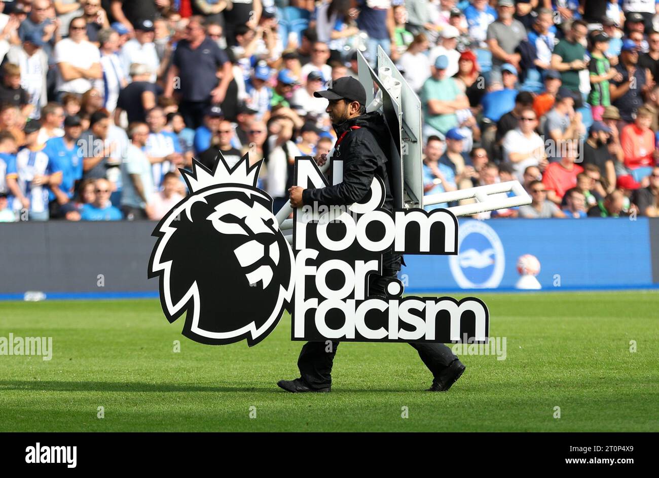 A person carries a No Room For Racism sign before the Premier League ...